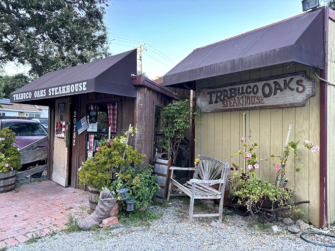 The unassuming wooden exterior of Trabuco Oaks Steakhouse promises rustic charm and serious steak business. Those barrel planters aren't just for show&mdash;they're your first hint of the no-nonsense authenticity waiting inside.