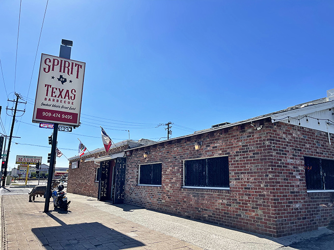 The brick exterior of Spirit of Texas BBQ stands like a meaty embassy on California soil, promising authentic Lone Star flavors under clear blue skies.
