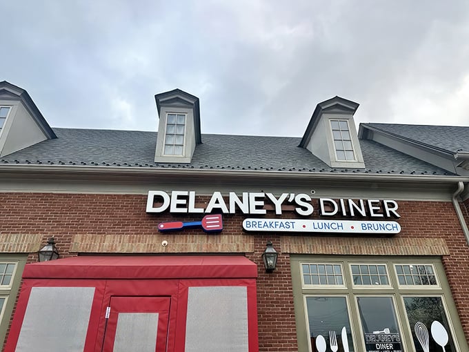 The brick facade and bright red doors of Delaney's Diner stand like a beacon of breakfast hope on East Main Street in Columbus.