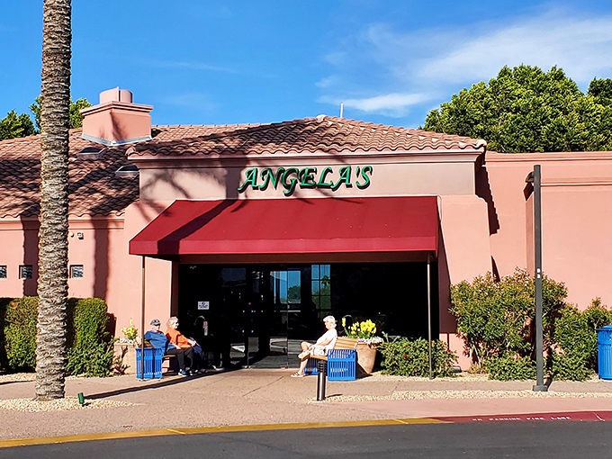 Angela's Kitchen welcomes you with its warm terracotta exterior and inviting red awning&mdash;a culinary oasis amid the Arizona desert landscape.