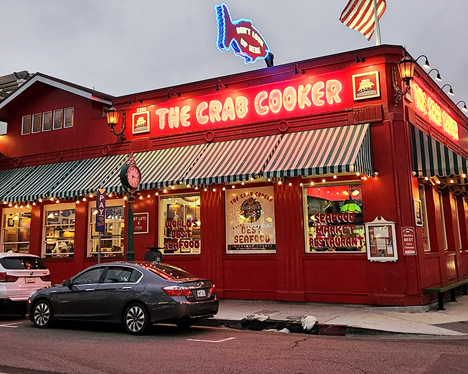 The bright red exterior of The Crab Cooker glows like a culinary lighthouse, beckoning seafood lovers to Newport Beach's most unpretentious treasure.