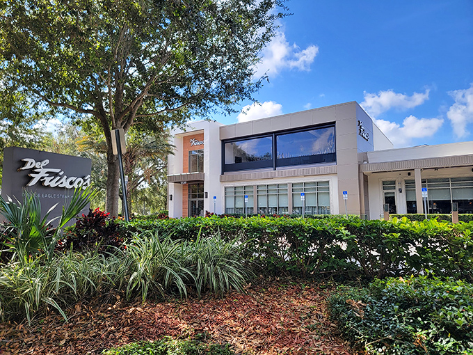 Modern elegance meets Florida charm at Del Frisco's exterior, where palm trees stand guard over what might be the best steak-eating decision of your life.