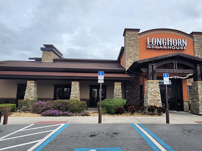 The Western-inspired facade of LongHorn Steakhouse stands like a carnivore's oasis amid Orlando's tourist landscape, promising refuge for the steak-starved traveler.