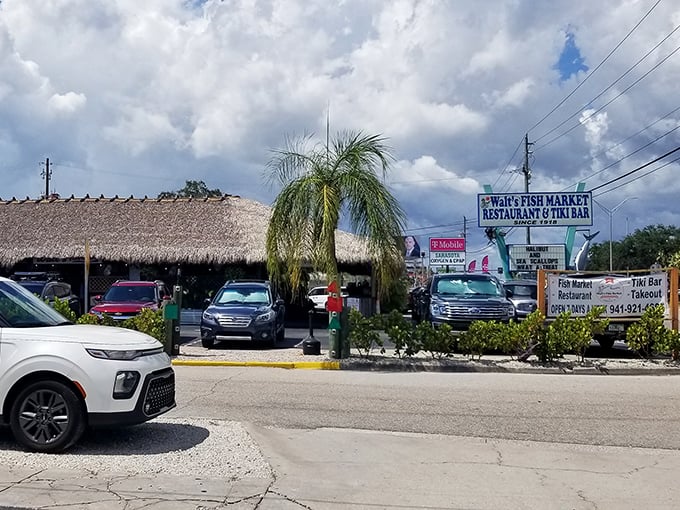 The thatched-roof paradise of Walt's Fish Market beckons like a mirage on Tamiami Trail, promising seafood treasures beneath its tropical canopy.