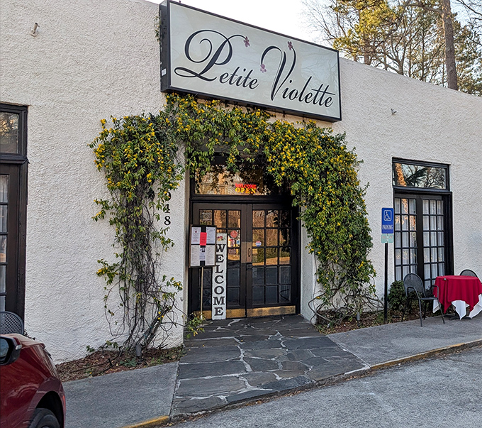 The unassuming exterior of Petite Violette belies the culinary treasures within, like finding a Michelin star hiding behind a garden trellis.
