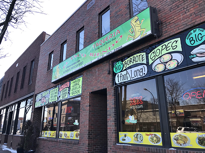 El Taco Riendo's vibrant storefront announces its presence with neon-bright menu boards that practically scream, "Yes, this is the real deal!"