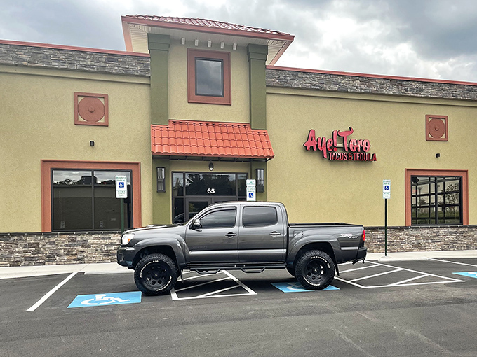 The golden-hued exterior of Aye! Toro stands like a beacon of culinary promise in Pittsboro, its terracotta accents and stonework hinting at the authentic flavors waiting inside.