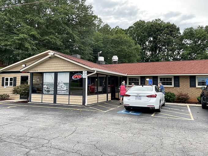 Unassuming culinary treasures often hide in plain sight. This modest brick building in Dallas, NC houses seafood magic that would make coastal restaurants envious.