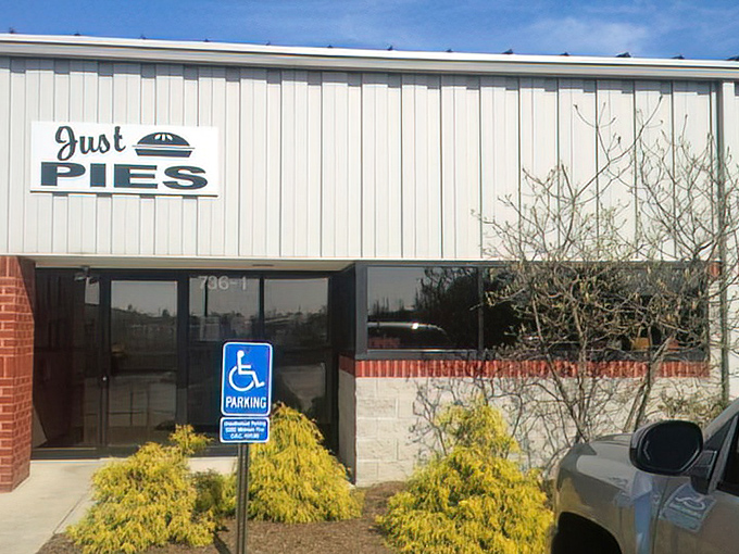 The unassuming exterior of Just Pies proves once again that culinary greatness rarely comes with flashy packaging.