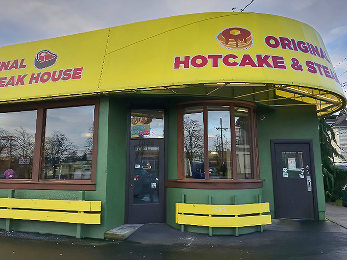 The green building with its sunshine-yellow awning stands like a beacon of breakfast hope on Powell Boulevard. No architectural awards here&mdash;just promises of pancake perfection. 