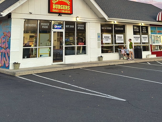 The white building with vibrant mural screams "comfort food lives here!" Old School Burgers stands proud in Willow Grove, promising nostalgic flavors without pretension.