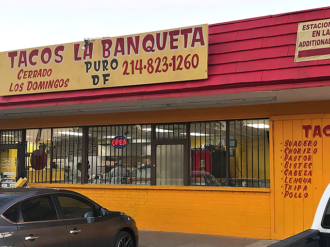 The bright red exterior of Tacos La Banqueta stands out like a beacon of hope for hungry travelers. No fancy architecture needed when the food speaks this loudly.