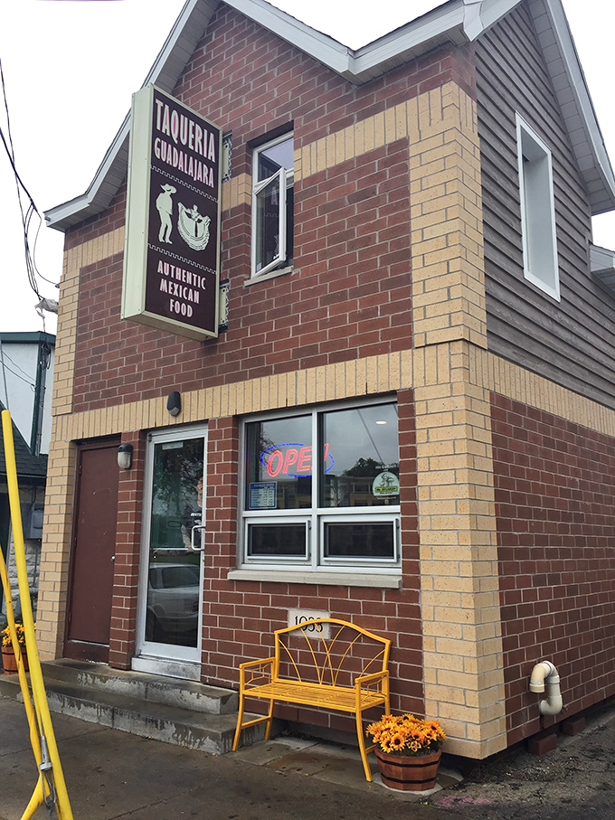 The unassuming brick exterior with that eye-catching pink bench is like a secret handshake &ndash; those who know, know this is where Madison's burrito magic happens.