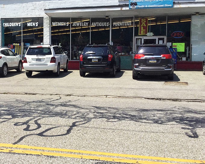 The red-brick storefront with its "WOMEN'S JEWELRY ANTIQUES FURNITURE" signage promises treasures within &ndash; Erie's own cabinet of curiosities awaits!