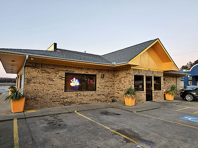 The unassuming brick exterior of El Amigo Feliz stands like a culinary oasis in Hazen, bright orange planters hinting at the vibrant flavors waiting inside.