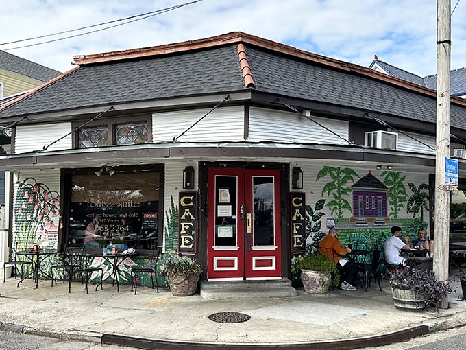 The corner cafe with its iconic red doors and palm tree murals stands like a breakfast beacon in Algiers Point, inviting hungry souls to step inside.