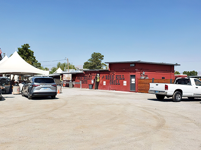 The bright red exterior of Road Kill Grill stands like a barbecue beacon in North Las Vegas, promising smoky delights within those unassuming walls. 