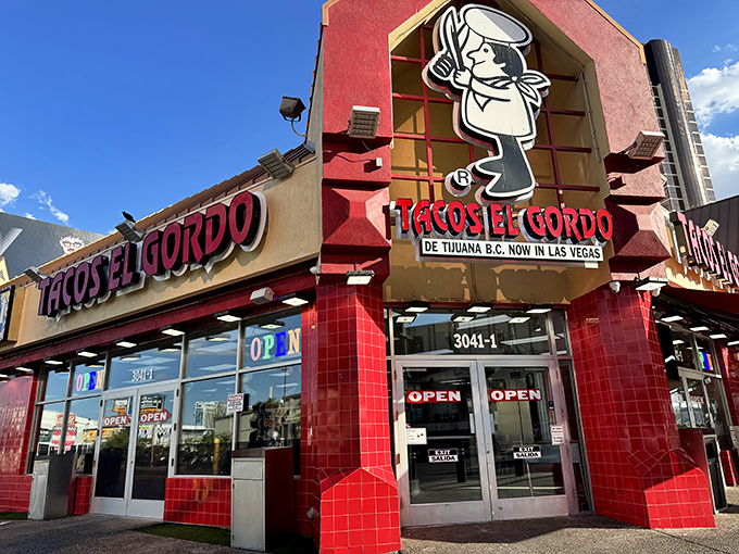 The vibrant red exterior of Tacos El Gordo stands out like a beacon of hope for hungry souls wandering the Las Vegas desert.
