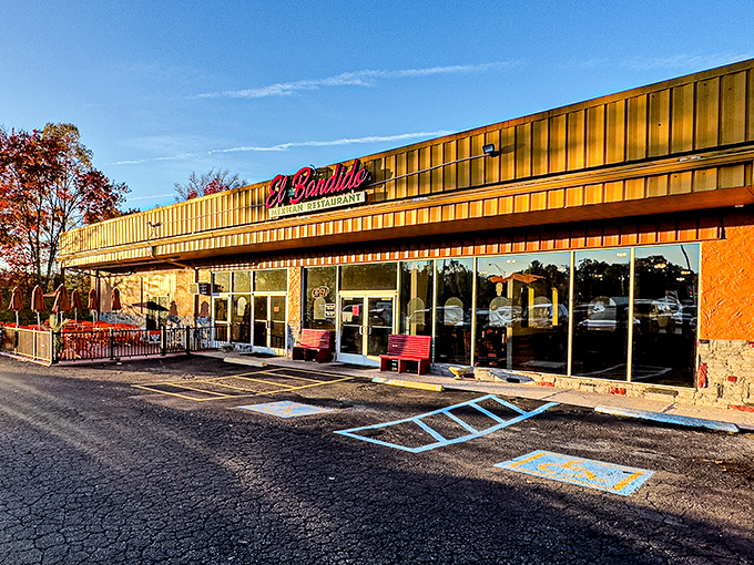 The golden glow of El Bandido's exterior promises culinary treasures within. Those red benches aren't just seating&mdash;they're the waiting room for flavor paradise.