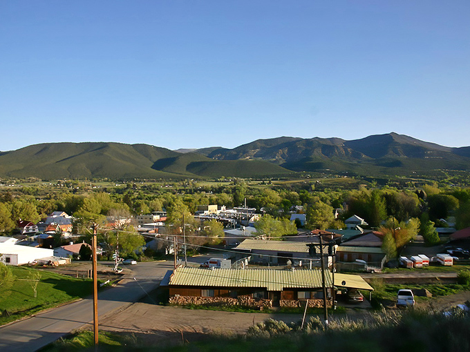 Downtown Paonia sits like a movie set against the dramatic backdrop of mountains, where storm clouds gather but never dampen the town's charm.