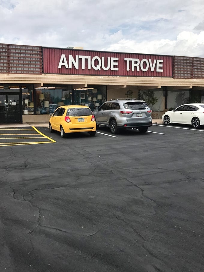 The unassuming exterior of Antique Trove hides a universe of treasures within, like finding a portal to the past disguised as a strip mall storefront.