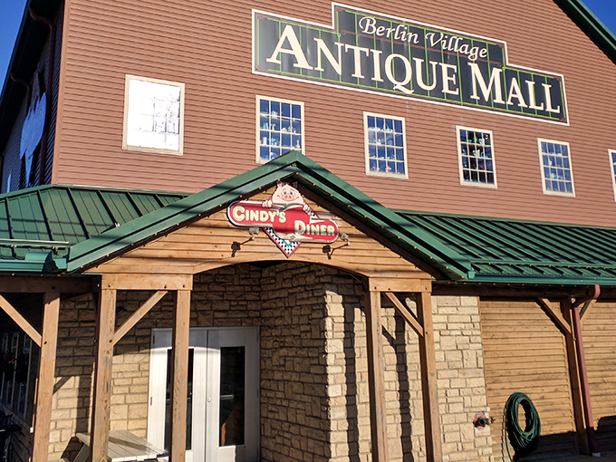 The unassuming exterior of Berlin Village Antique Mall beckons like a time portal disguised as a country store. Wooden charm with a promise of treasures within.