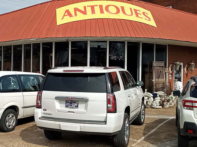 The unassuming exterior with its bold yellow "ANTIQUES" sign is like a treasure chest waiting to be opened. Adventure begins here!