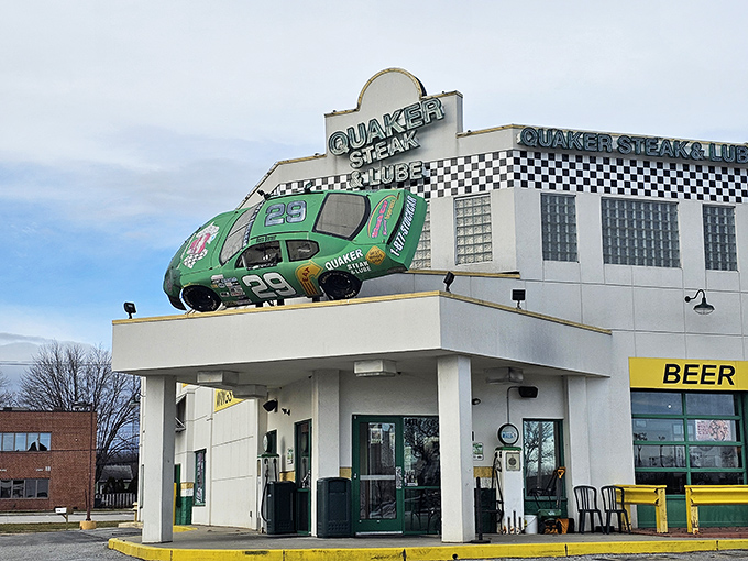 The ultimate pit stop for hungry travelers! Quaker Steak & Lube's iconic exterior features a green NASCAR-style race car that's permanently parked on the roof.