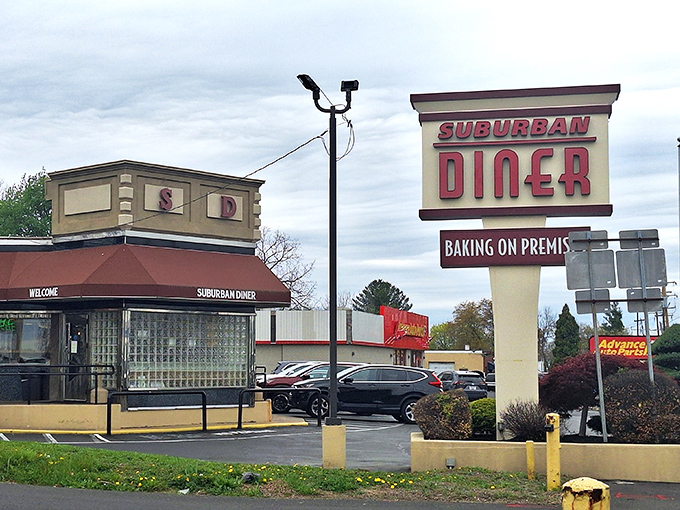The iconic Suburban Diner sign promises "BAKING ON PREMIS" &ndash; a charming typo that somehow makes the anticipation of fresh-baked goods even more endearing. 