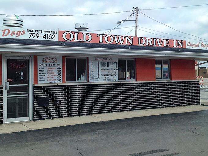 The bright orange facade of Old Town Drive-In stands as a beacon of burger bliss in Saginaw, promising nostalgic flavors that modern fast food chains can only dream of replicating.