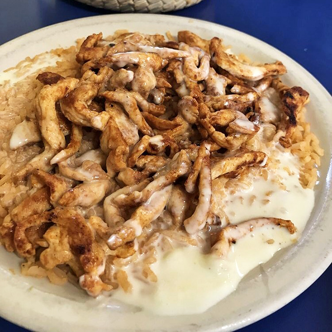 Arroz con Pollo that your abuela would approve of—tender chicken nestled in a creamy sauce atop perfectly cooked rice. Comfort food speaks all languages.