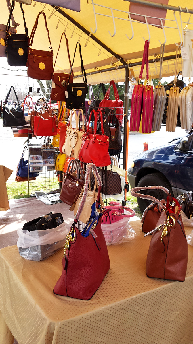 Designer-inspired handbags in every hue dangle like colorful fruit, tempting fashion-conscious shoppers with affordable luxury.