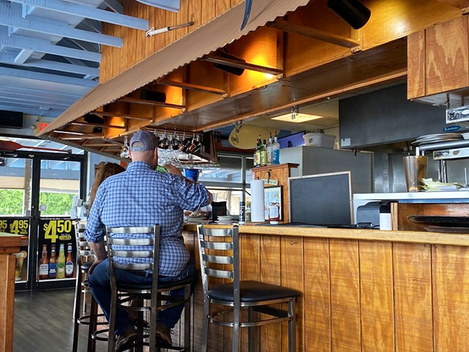 The bar area&mdash;where locals perch like seasoned pelicans, knowing exactly where the good stuff is found. 