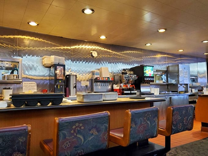 The counter where regulars perch like birds on a telephone wire, watching breakfast magic happen in real time.