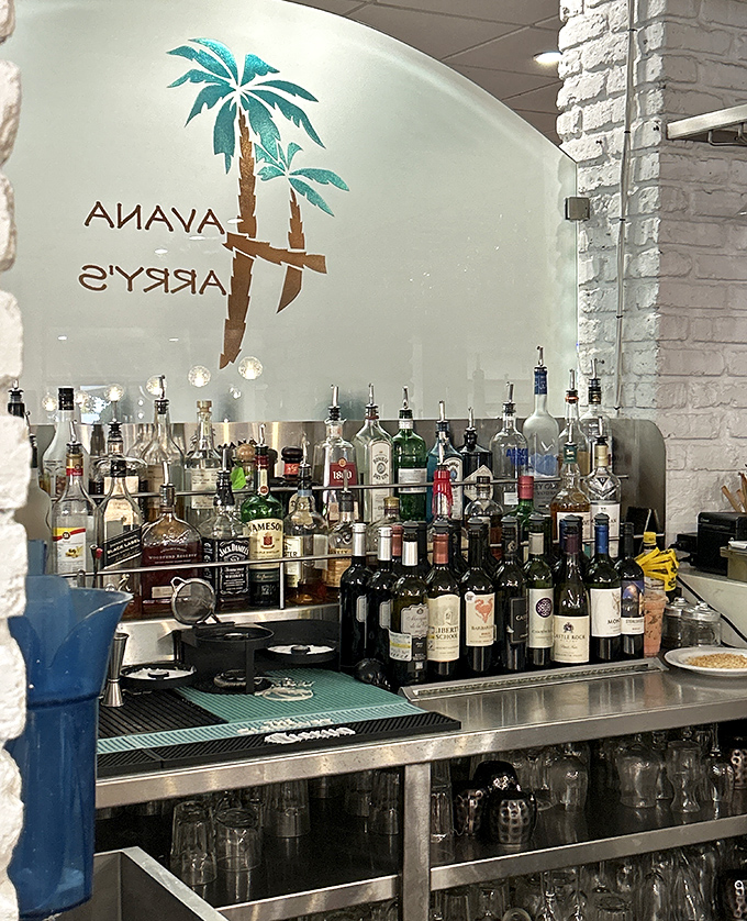 Behind this bar, liquid alchemy happens daily—tropical cocktails and classic Cuban libations emerge from a forest of premium spirits.