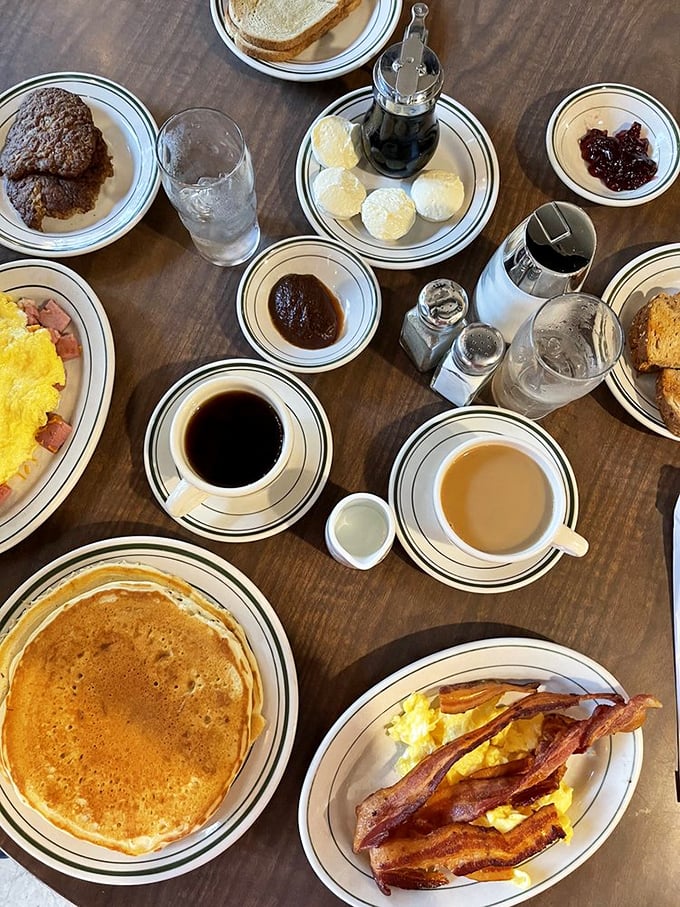 A breakfast spread that says "cancel your lunch plans"&mdash;pancakes, eggs, bacon, and coffee creating the ultimate morning symphony. 