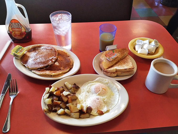 Breakfast of champions: golden pancakes, perfectly cooked eggs, and home fries that make you wonder what magic happens in that kitchen.