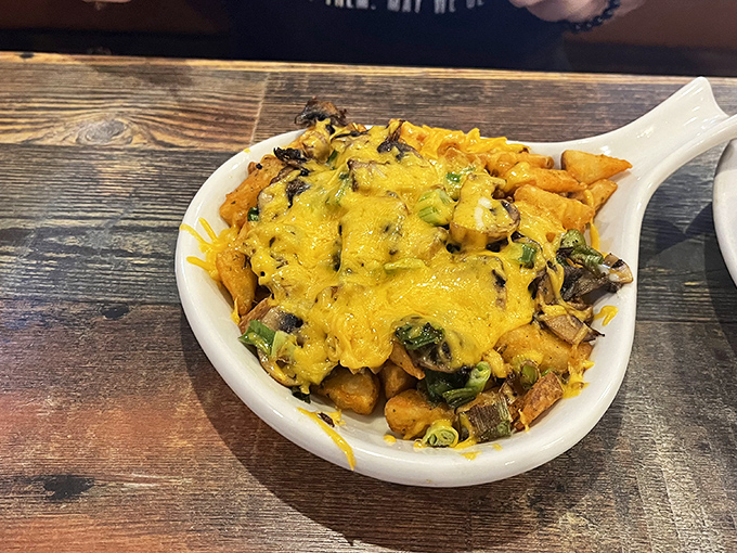 Potatoes achieving their highest purpose: smothered in cheese, vegetables, and possibly enough calories to fuel a small tractor.