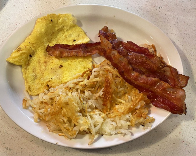 The breakfast trifecta: crispy bacon, fluffy eggs, and hash browns that strike the perfect balance between crisp and tender.