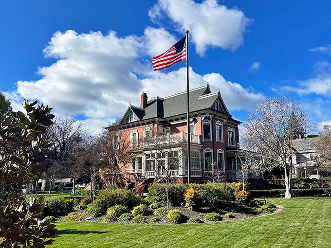 Buck Mansion stands proudly under clear skies, a Victorian testament to when craftsmanship mattered and homes weren't built with planned obsolescence.