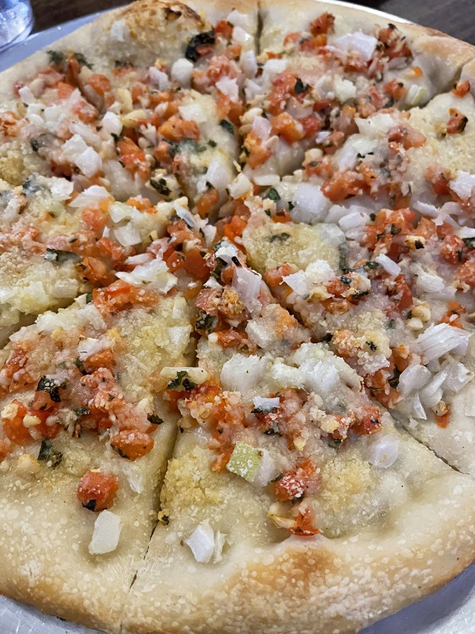 A white pizza that whispers sweet nothings to your taste buds. Fresh tomatoes, herbs, and a perfect crust that's neither too thick nor too thin.
