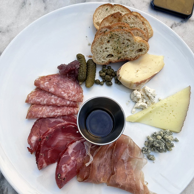 A charcuterie board so perfectly arranged it seems criminal to disturb it &ndash; but disturb it you must, because these flavors demand attention.