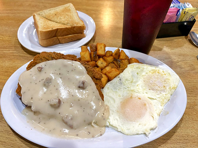 Country fried steak smothered in sausage gravy &ndash; because some mornings require serious fortification against whatever the day might throw at you.