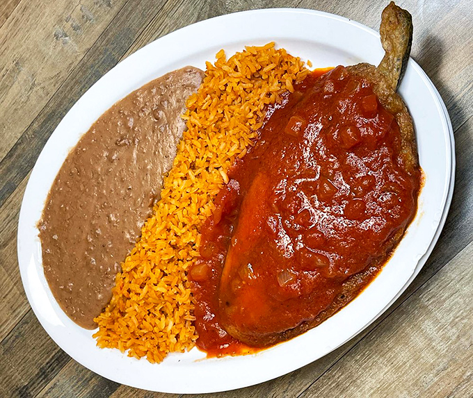 A chile relleno that could make a grown Midwesterner weep with joy. That perfect trio of rice, beans, and sauce-smothered pepper is comfort food elevated to art.