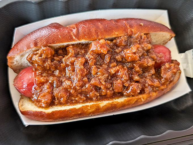 The chili dog in its natural habitat&mdash;a pretzel bun throne supporting a meaty monarch topped with a lava flow of savory goodness.