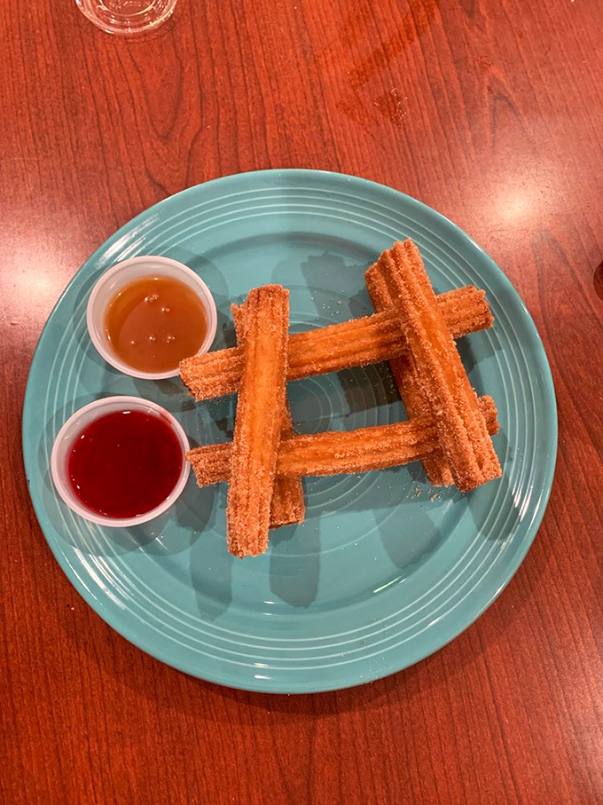 Churros arranged like delicious Lincoln Logs, with dipping sauces that make you question why we don't eat dessert first more often.
