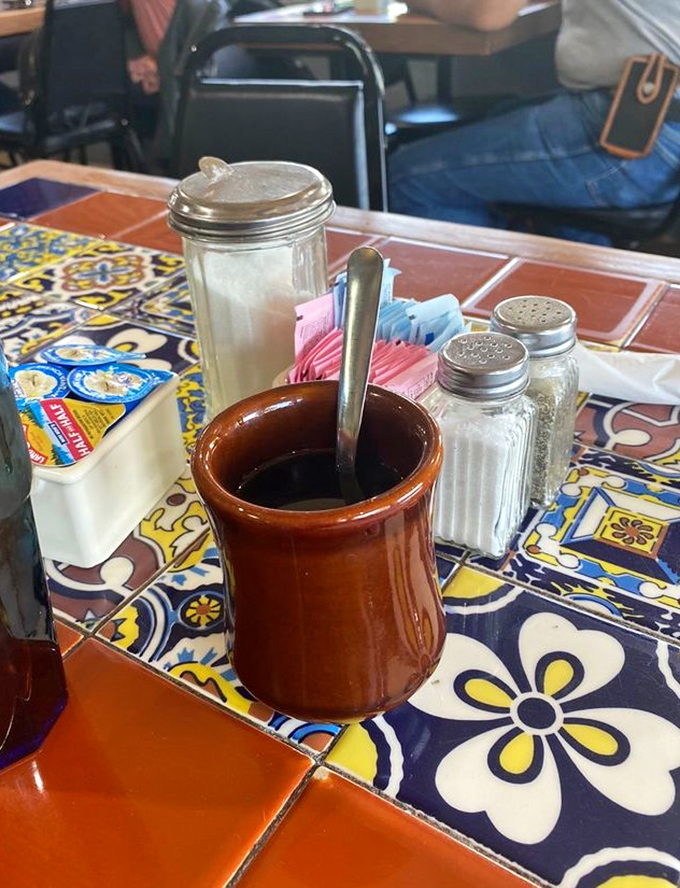 The coffee comes in a mug that feels like it belongs in your hand, promising infinite refills and zero pretension.