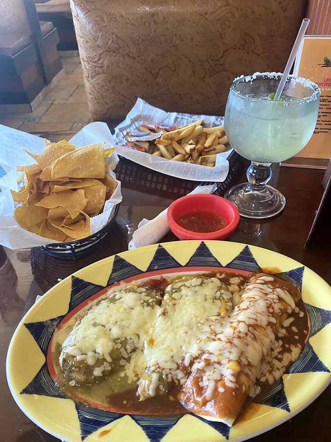A fiesta on a plate where refried beans and enchiladas coexist in perfect harmony, garnished with enough cilantro to make it official.