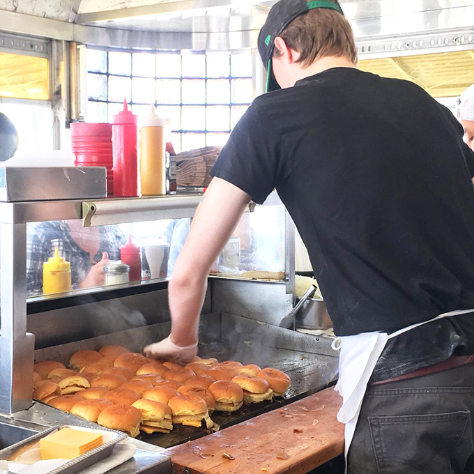 Burger ballet in progress. The griddle master orchestrates a symphony of sizzles as dozens of patties perform their mouthwatering metamorphosis.