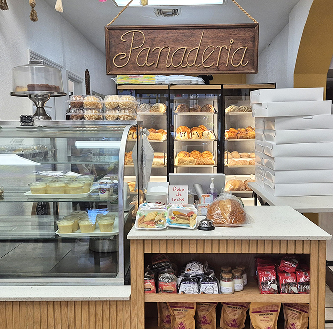Behind this counter, magic happens daily. The panaderia display case is where willpower goes to die a happy, sugar-dusted death.
